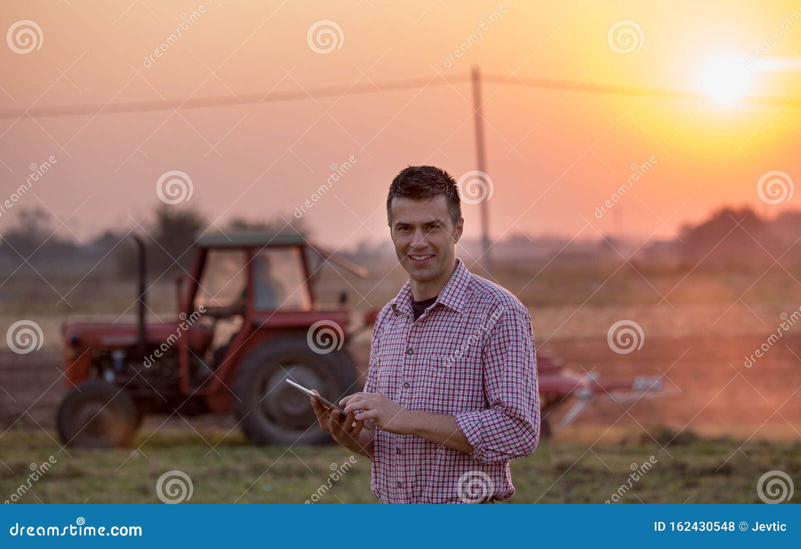 Farmer with Tablet in Front of Tractor Stock Photo - Image of farm ...