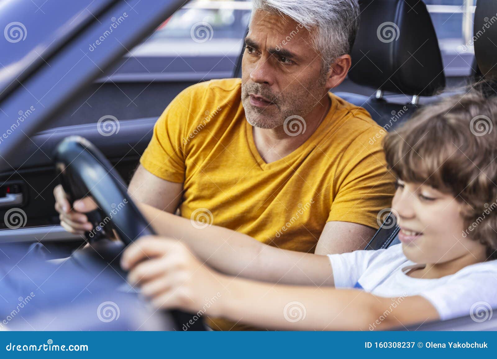 Handsome Father Teaching His Son How To Drive Vehicle Stock Image