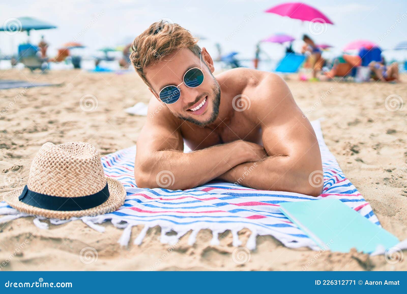 Handsome Fitness Caucasian Man At The Beach On A Sunny Day Sunbathing
