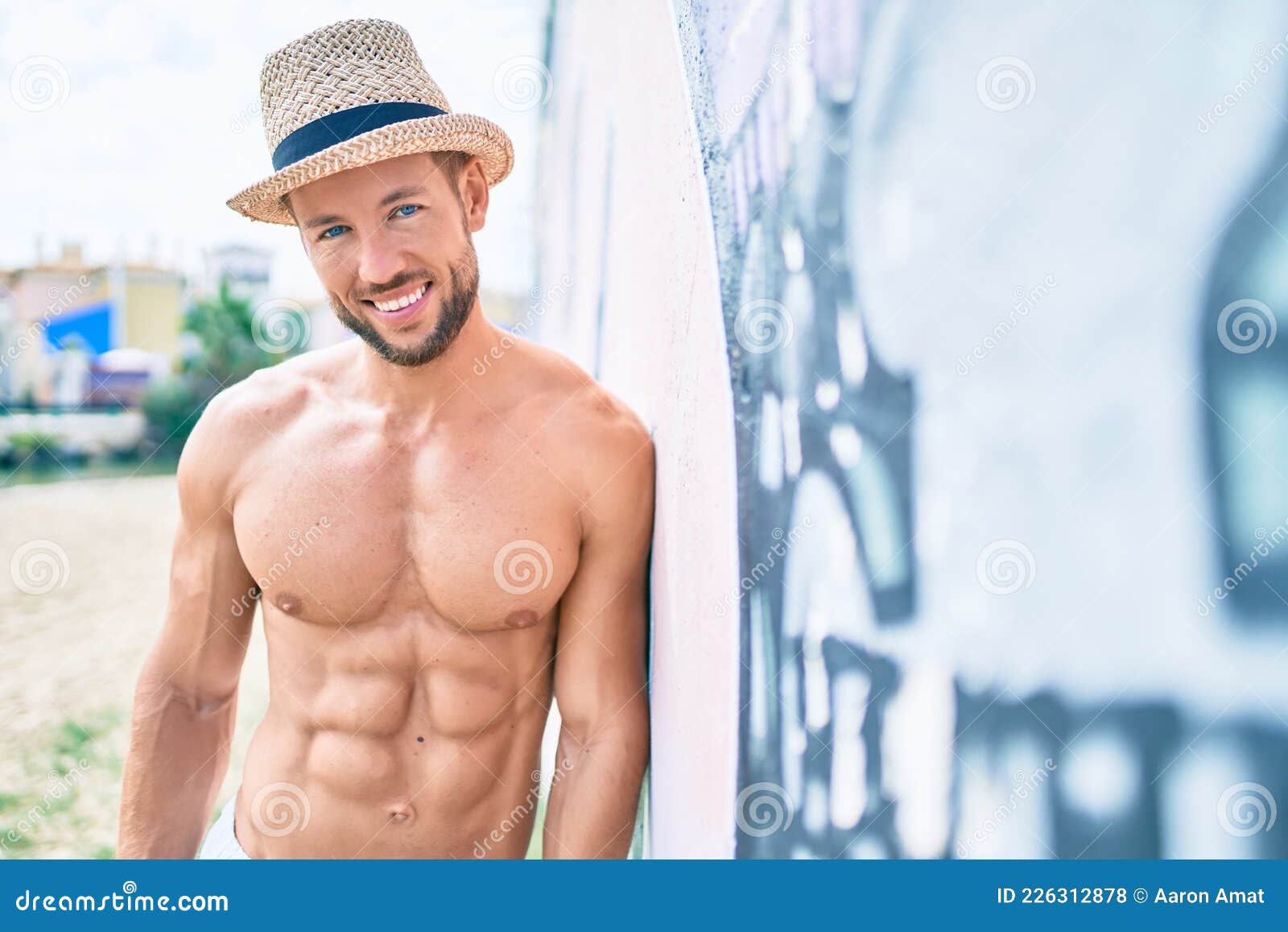 Handsome Fitness Caucasian Man At The Beach On A Sunny Day Wearing
