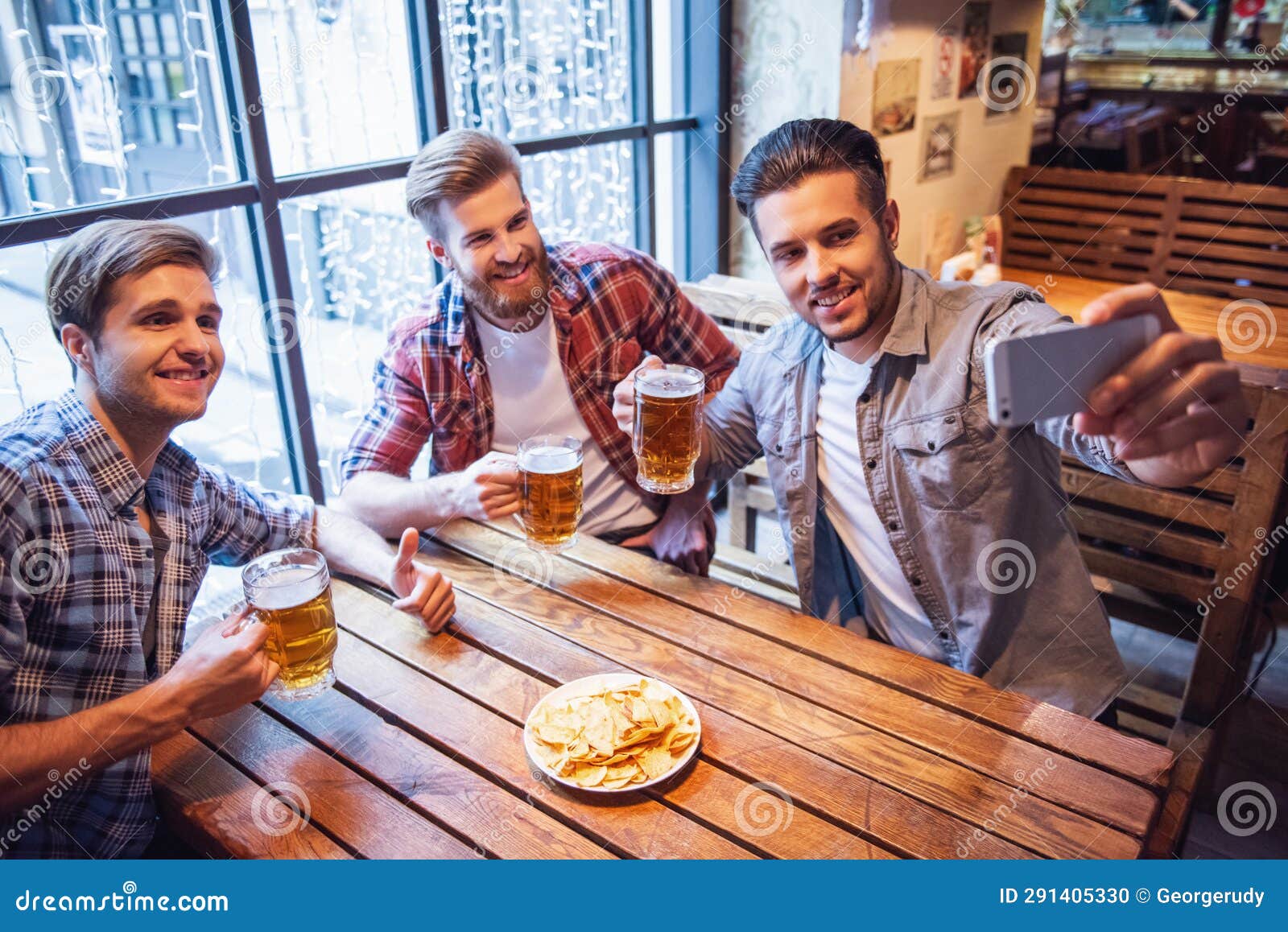 Friends at the pub stock photo. Image of indoors, friendship - 291405330