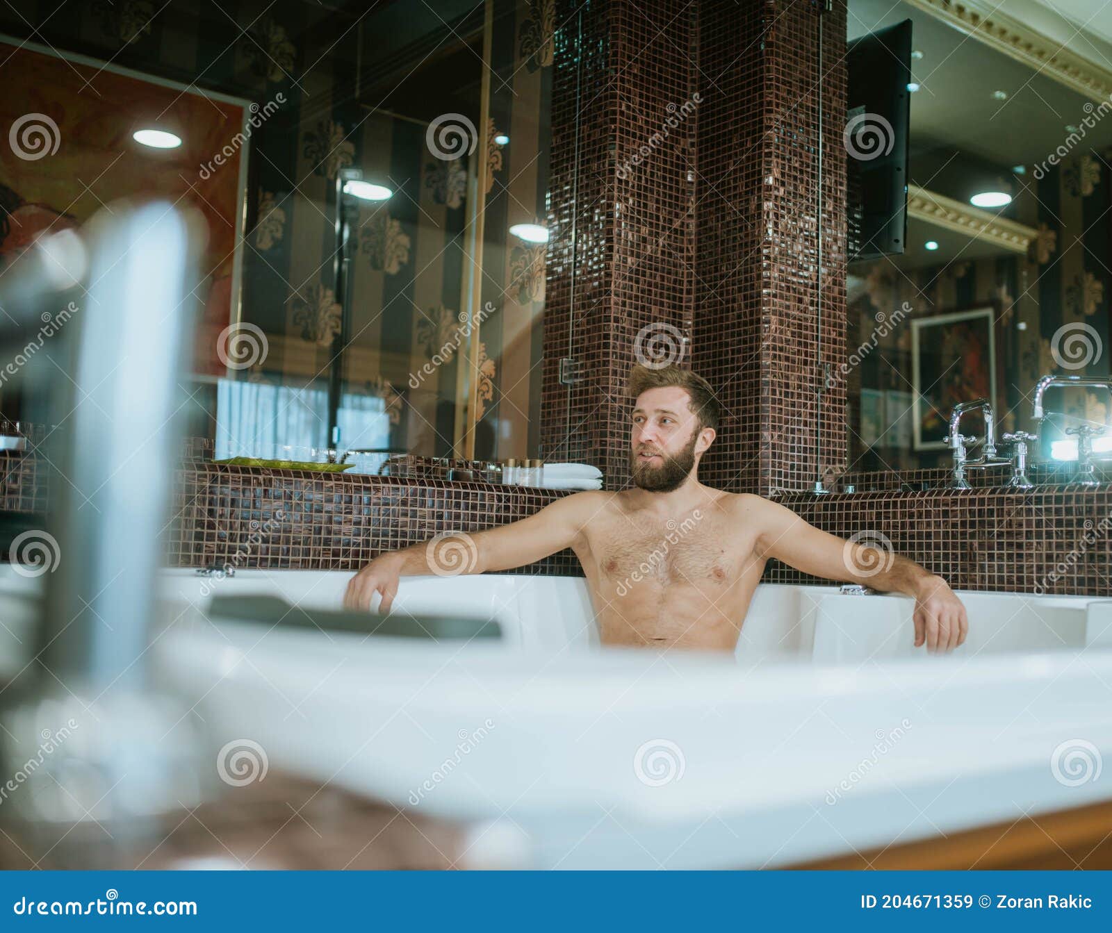 A Handsome Guy with a Beard is Sitting in the Hotel Jacuzzi Stock Image ...