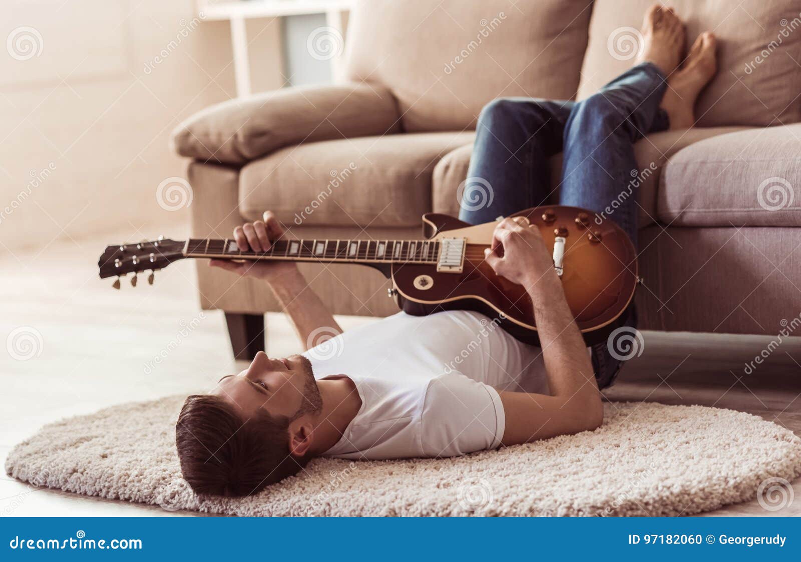 Handsome guy with guitar stock photo. Image of carpet - 97182060