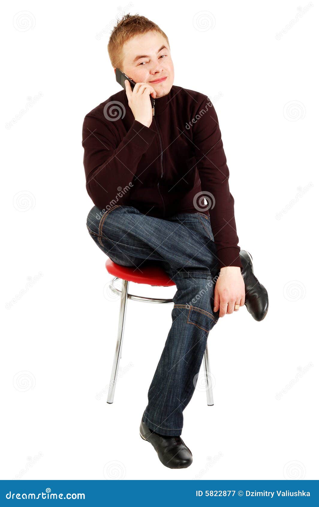 Handsome Guy Speaks by Mobile Sitting on a Chair Stock Image - Image of ...
