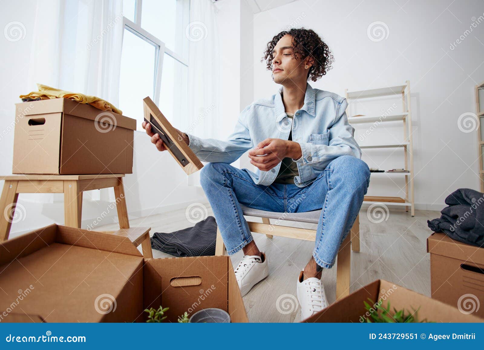 Handsome Guy Unpacking Things from Boxes in the Room Interior Stock ...