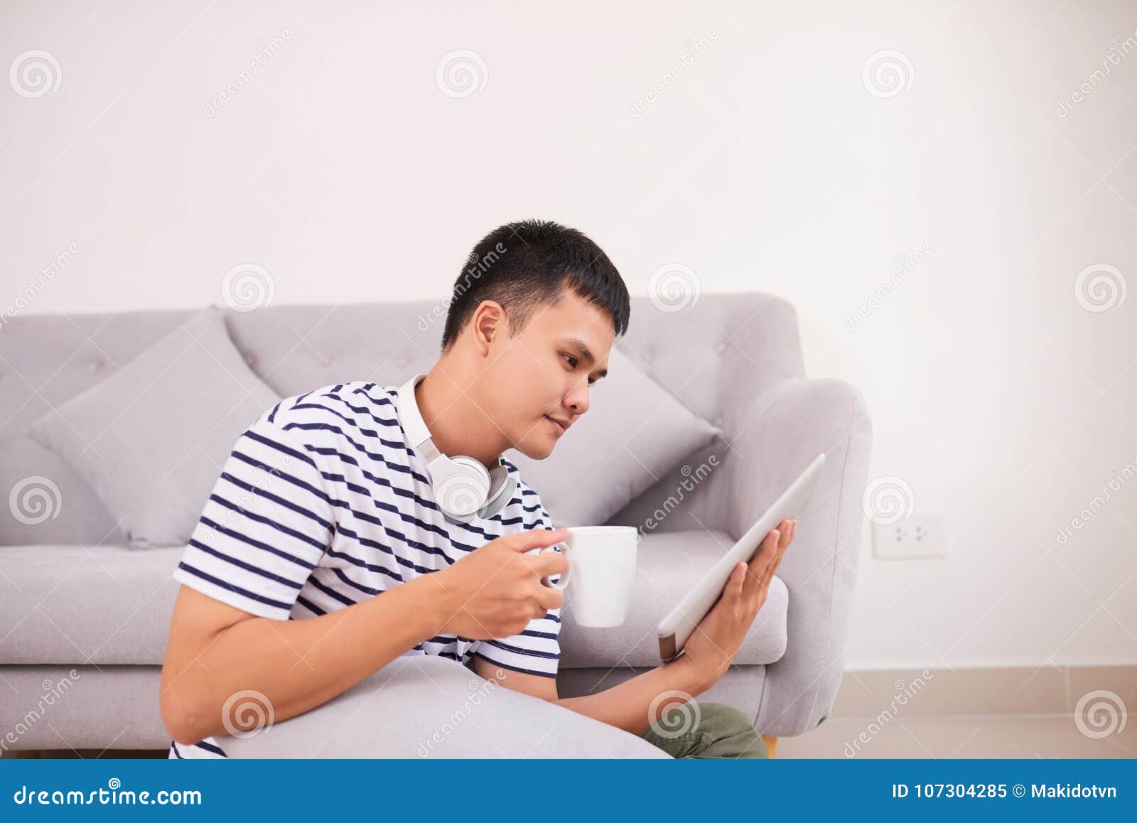 Handsome Guy is Using a Digital Tablet, Looking at Camera and Sm Stock ...