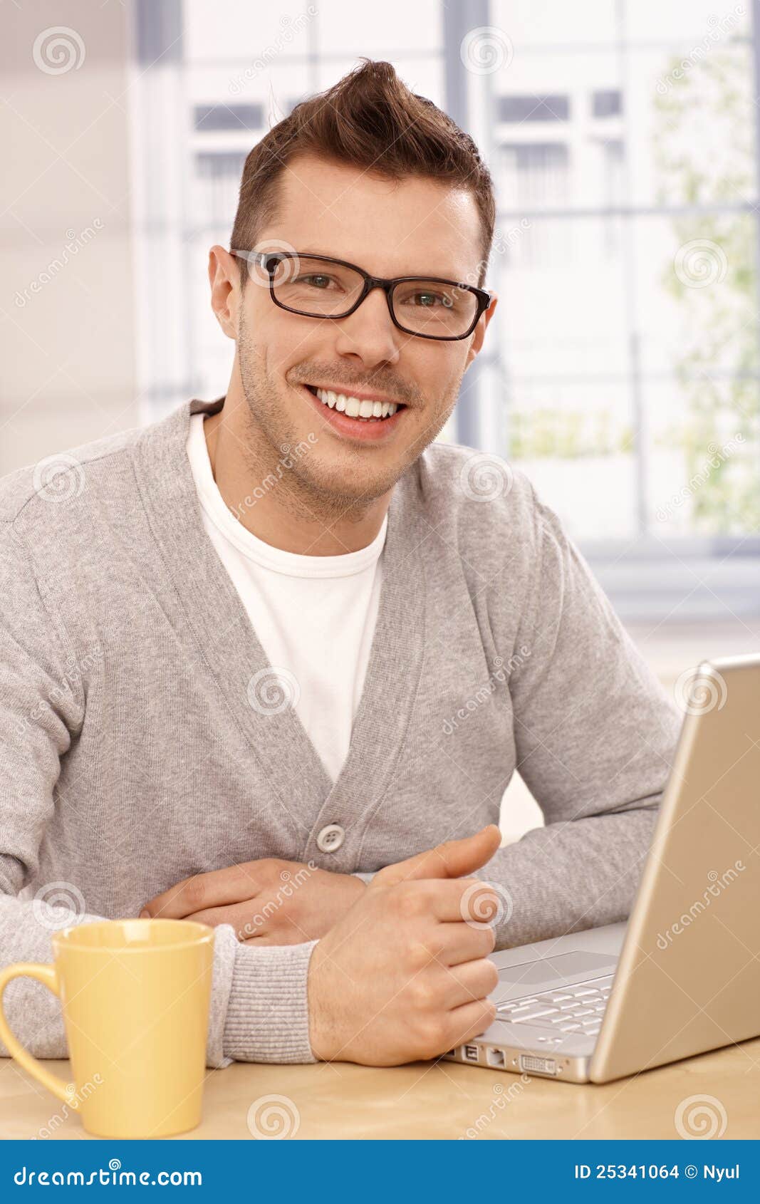 Handsome Guy Using Laptop Smiling Stock Photo - Image of color, hairdo ...