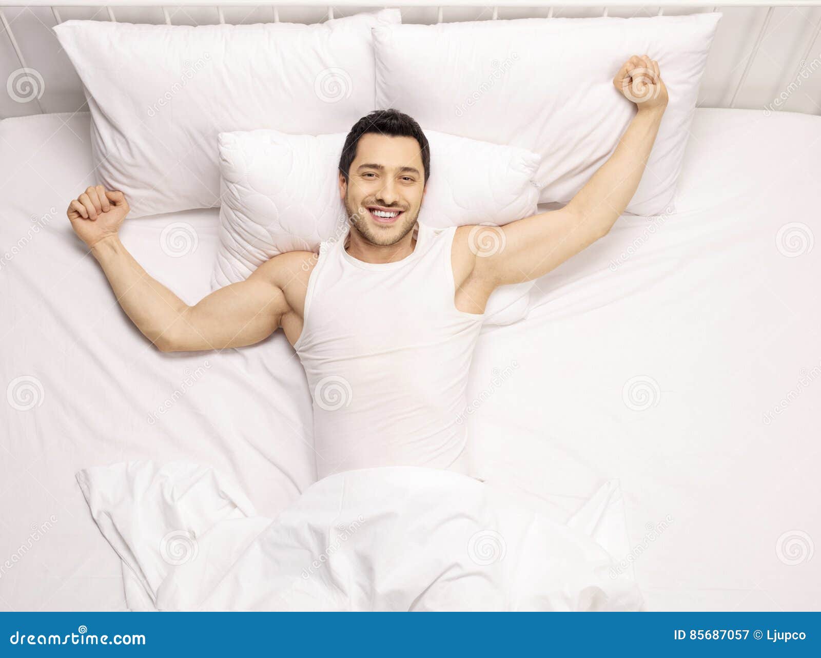 Handsome guy waking up stock image. Image of headboard - 85687057