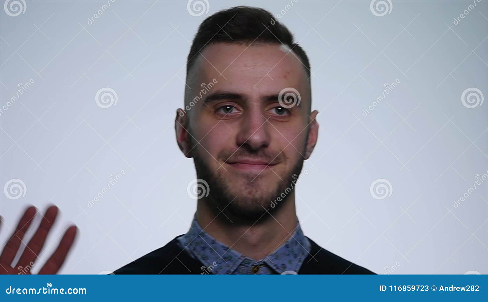 Handsome Guy Waving His Hand and Looking at the Camera Stock Video ...