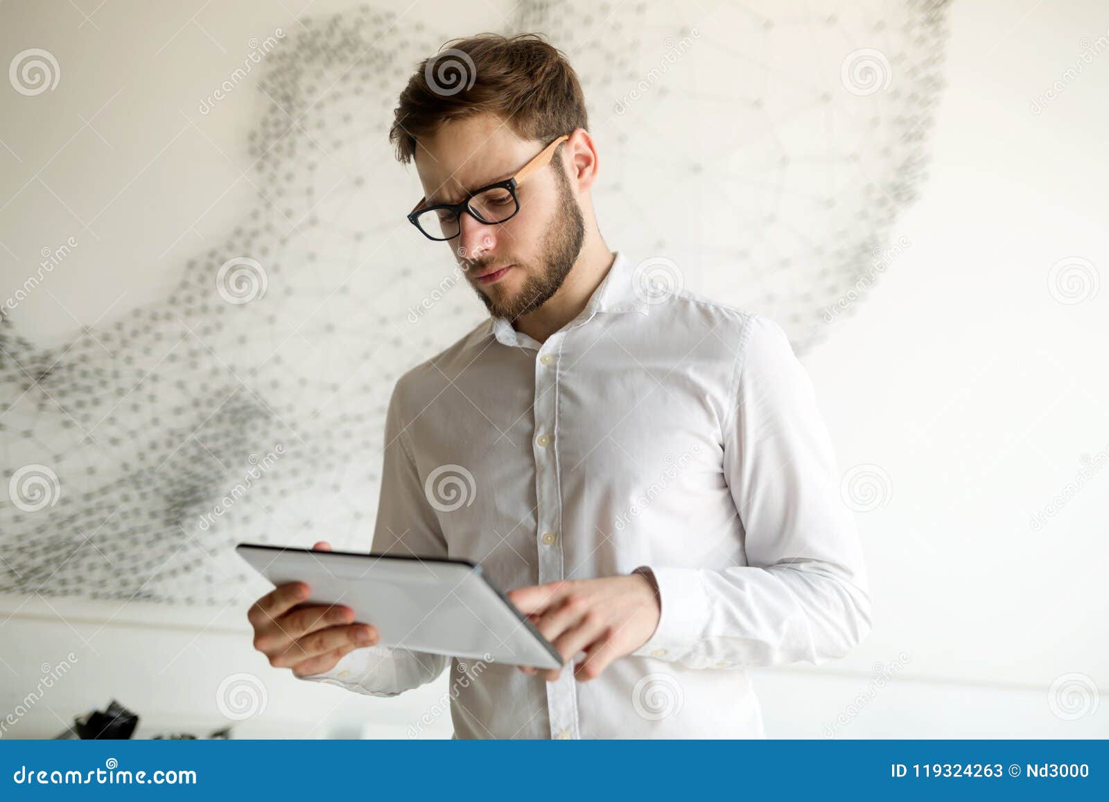 Handsome guy using tablet stock image. Image of person - 119324263