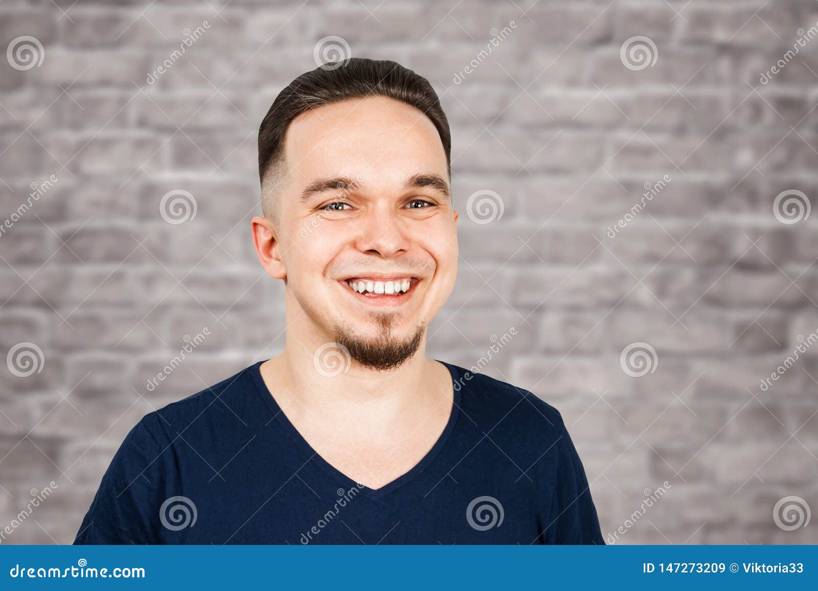 Handsome Guy with a Wide White Smile and Even Teeth on Brick Wall ...
