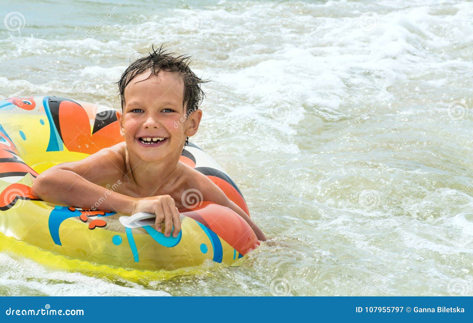 Handsome Happy Boy with Inflatable Ring Floating on the Sea, Waves and ...