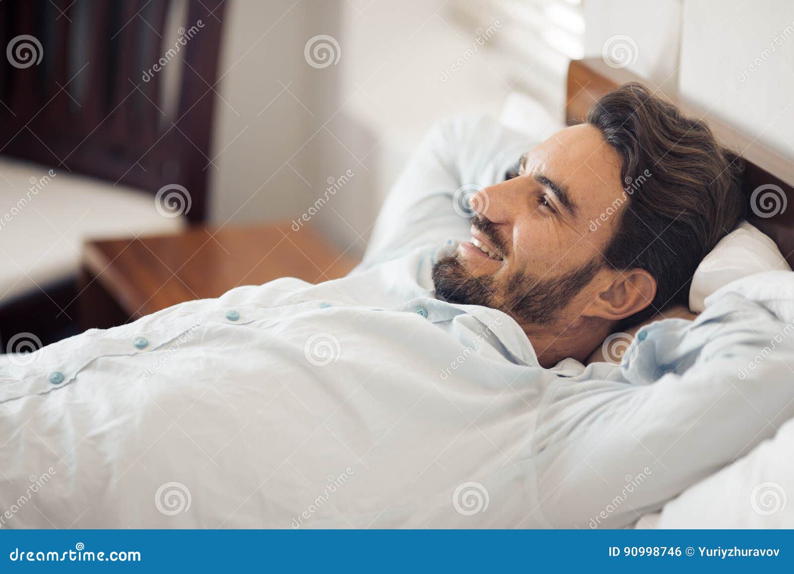 Handsome Happy Man Lying on Bed. Stock Photo - Image of handsome ...