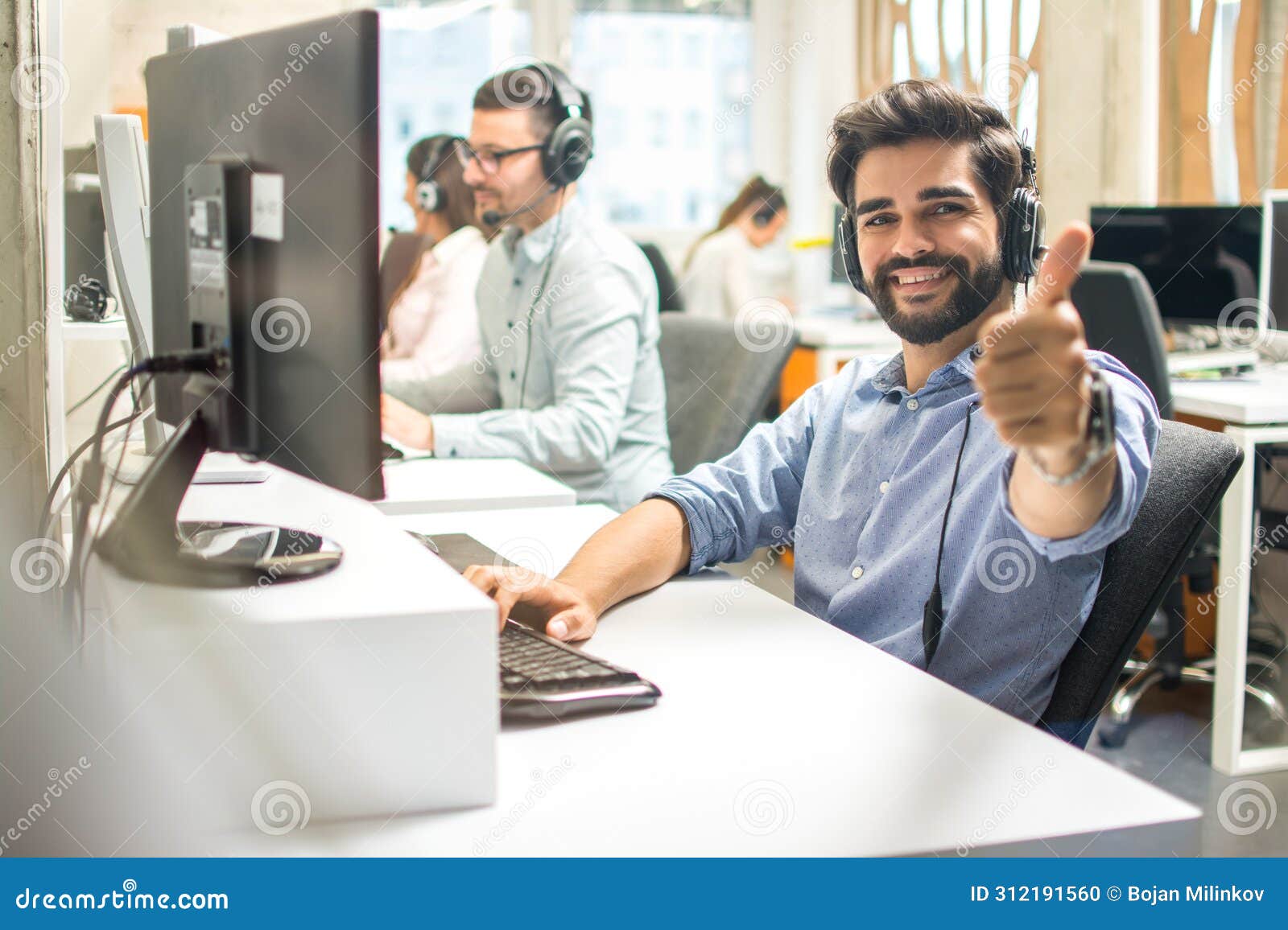 Handsome Helpline Operator Showing Thumb Up in Call Center Stock Photo ...