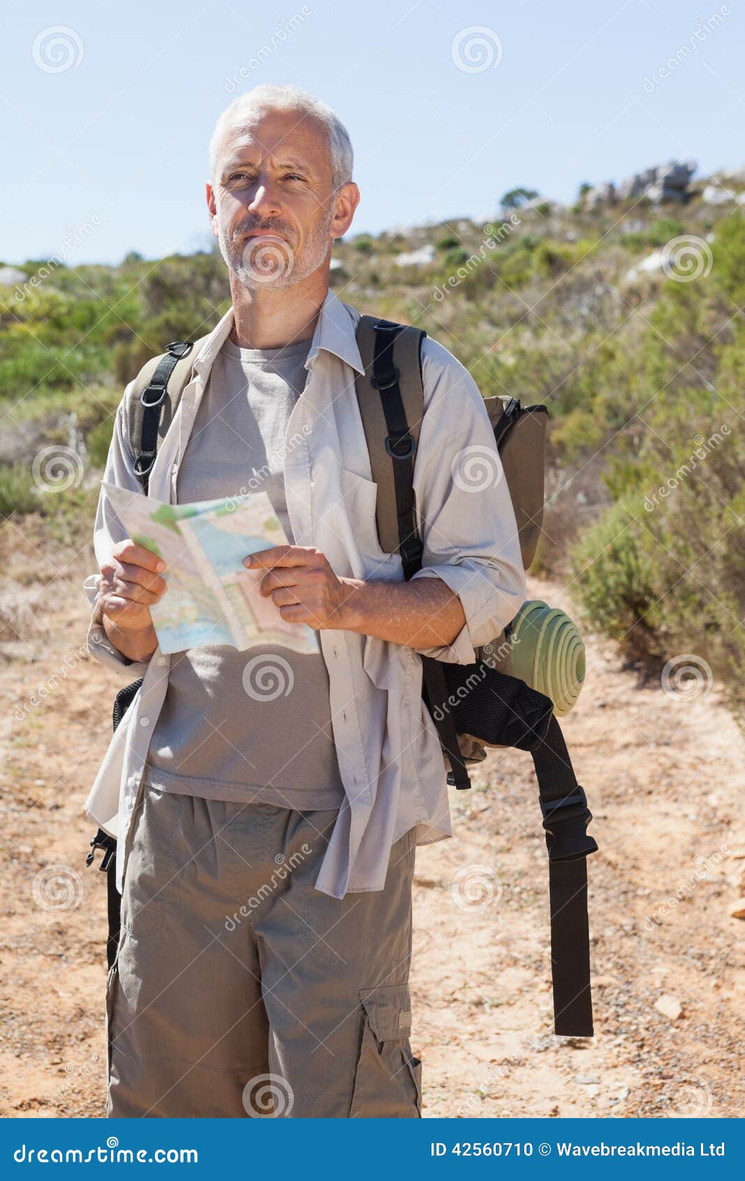 Handsome Hiker Consulting the Map in the Countryside Stock Photo ...
