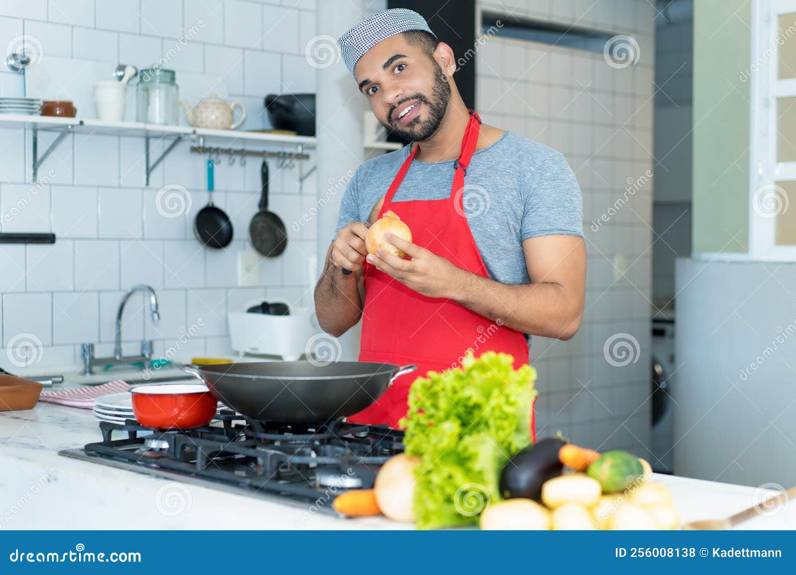 Handsome Hispanic Cook with Red Apron Preparing Food at Kitchen Stock ...
