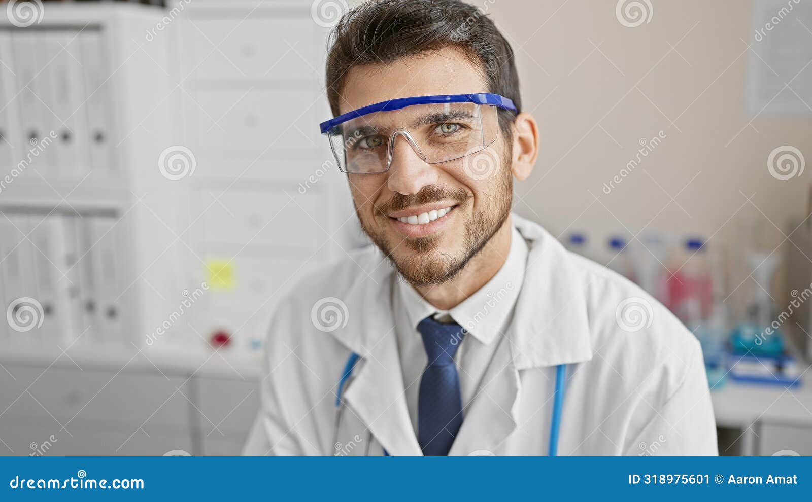 Handsome Hispanic Man with Beard in Lab Coat and Safety Glasses Inside ...
