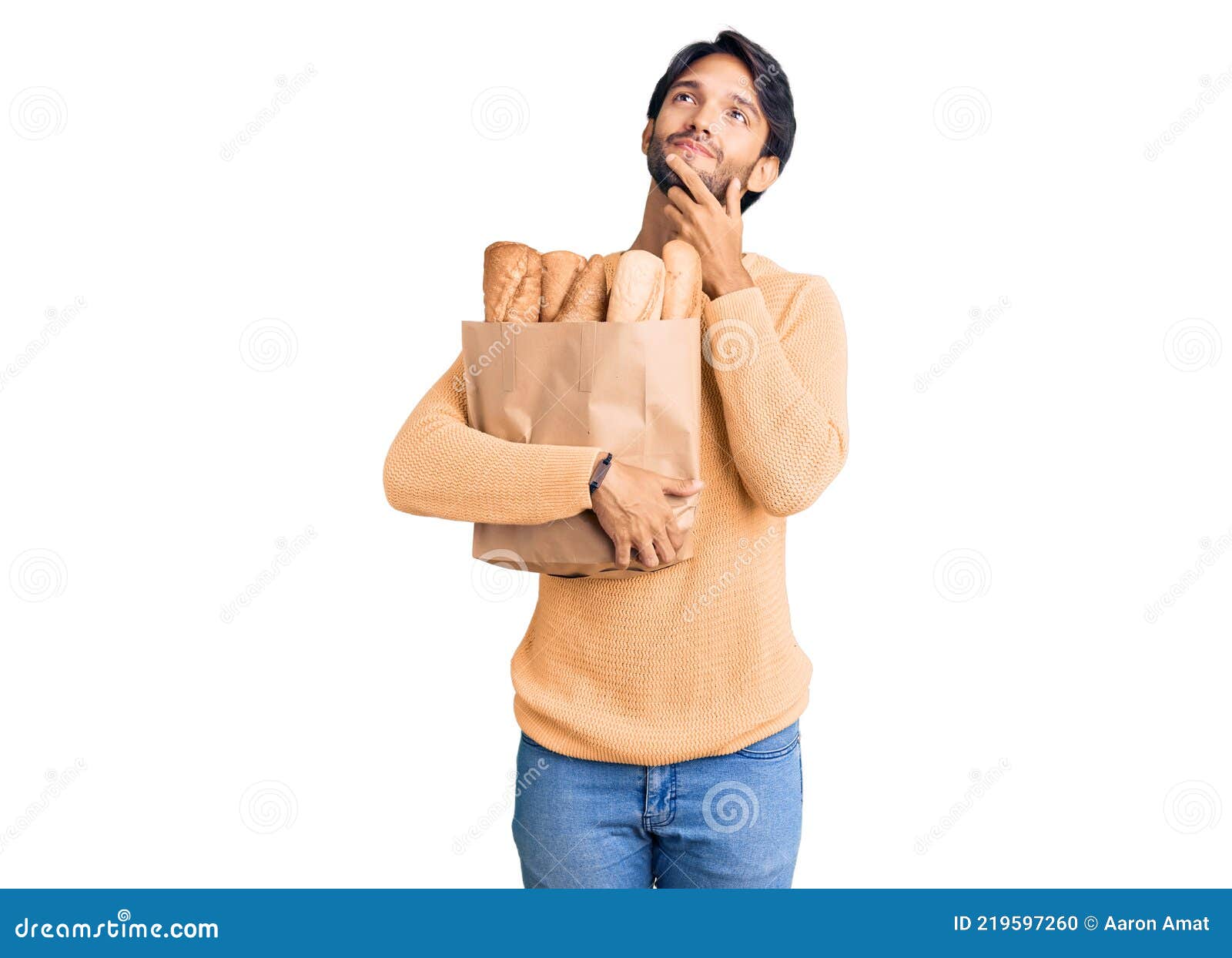 Handsome Hispanic Man Holding Paper Bag with Bread Serious Face ...