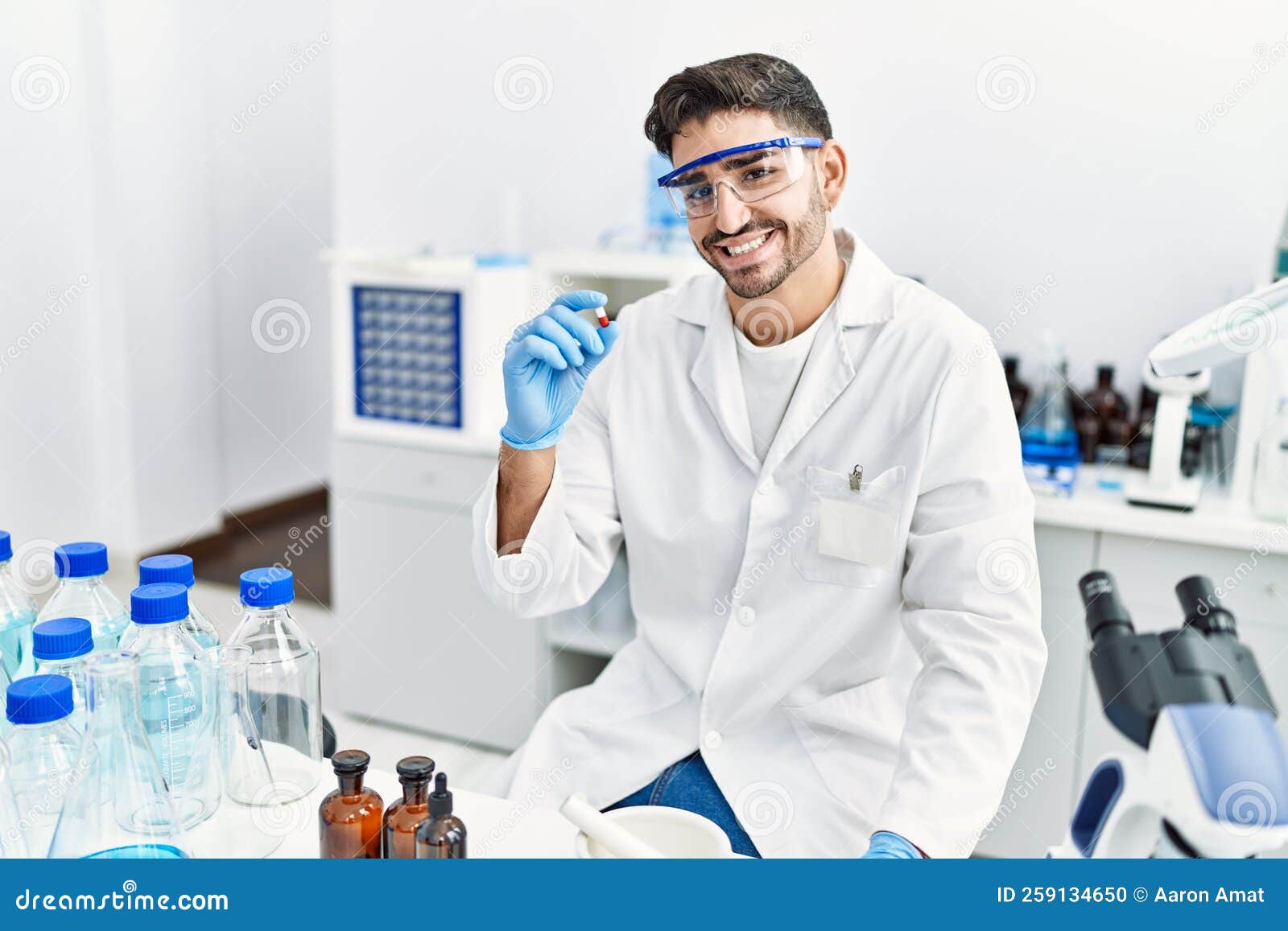 Handsome Hispanic Man Holding Pharmaceutical Pill at Laboratory Stock ...