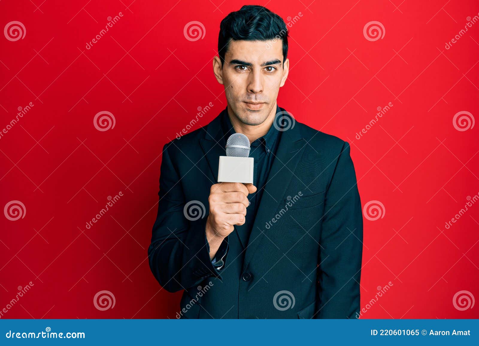 Handsome Hispanic Man Holding Reporter Microphone Thinking Attitude and ...