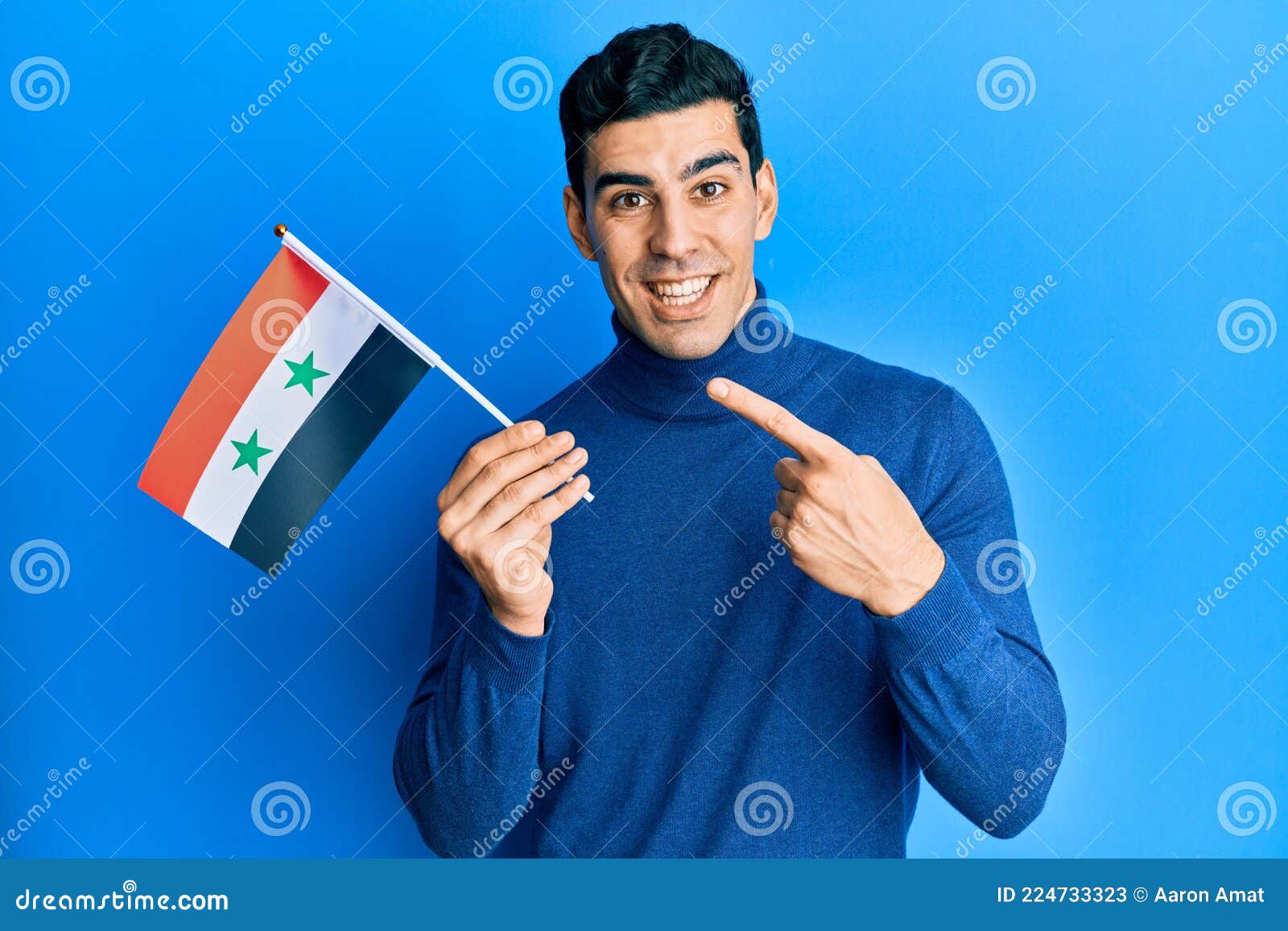 Handsome Hispanic Man Holding Syria Flag Smiling Happy Pointing with ... Handsome Hispanic Man Holding Syria Flag Smiling Happy Pointing with ...