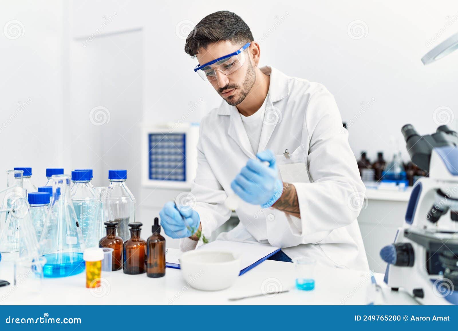 Handsome Hispanic Man Using Scientific Mortar at Laboratory Stock Photo ...