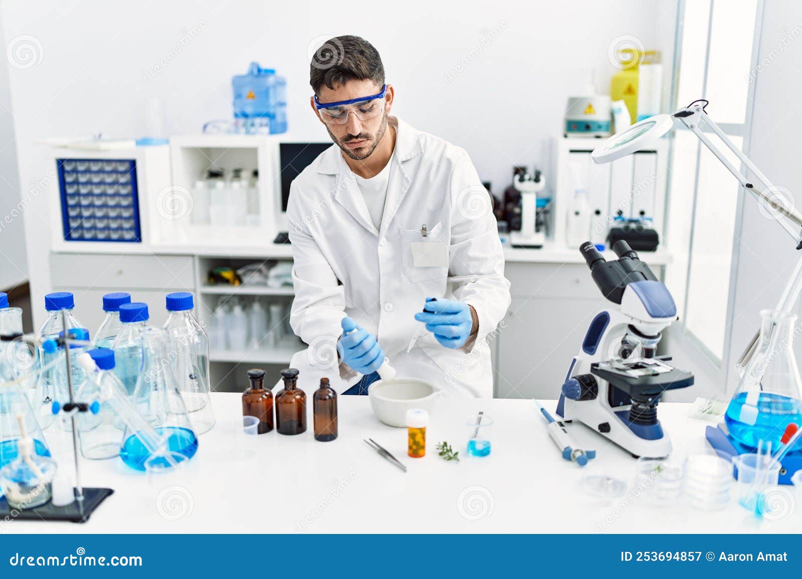 Handsome Hispanic Man Using Scientific Mortar at Laboratory Stock Image ...