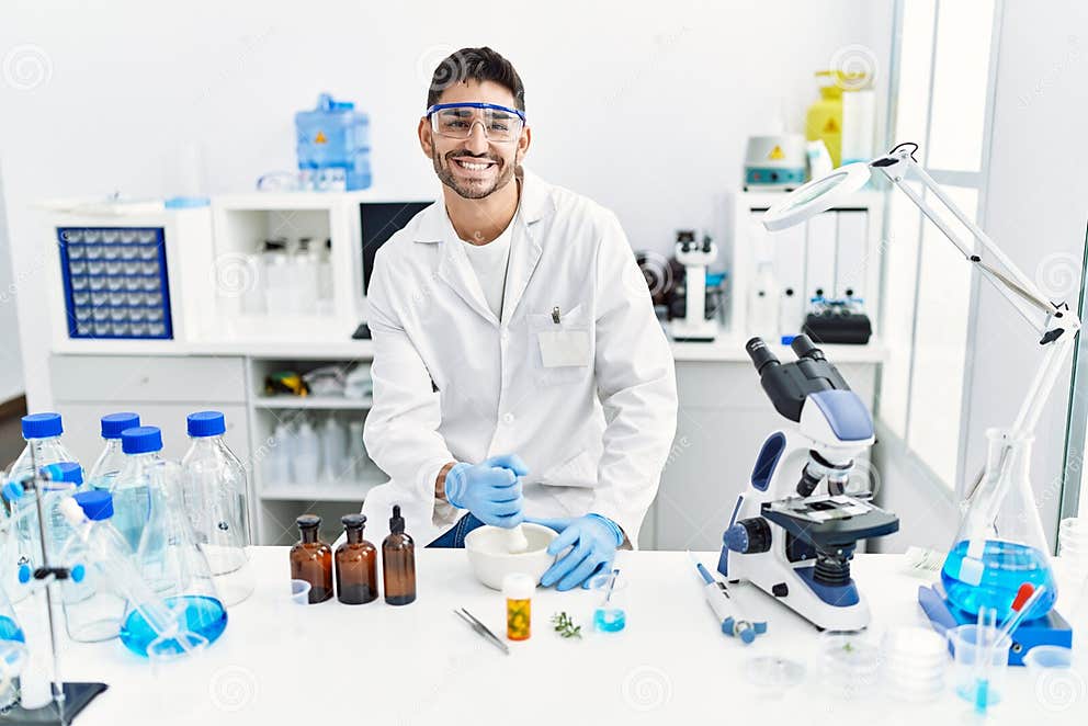 Handsome Hispanic Man Using Scientific Mortar at Laboratory Stock Image ...