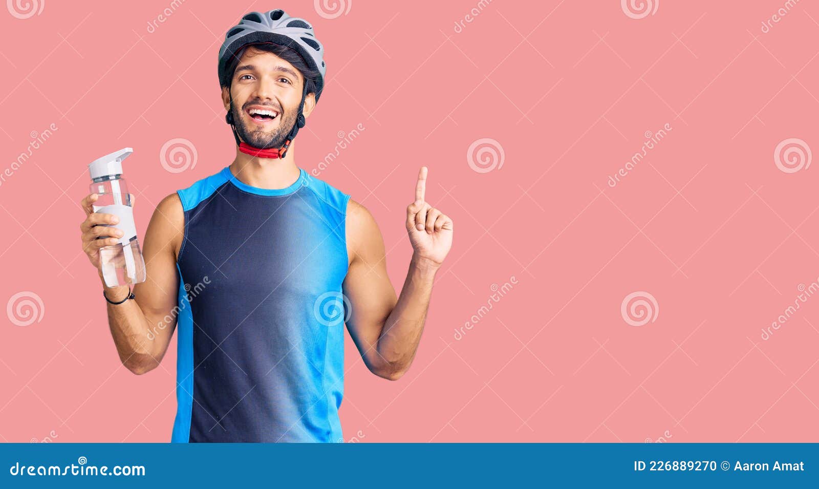 Handsome Hispanic Man Wearing Bike Helmet And Holding Water Bottle