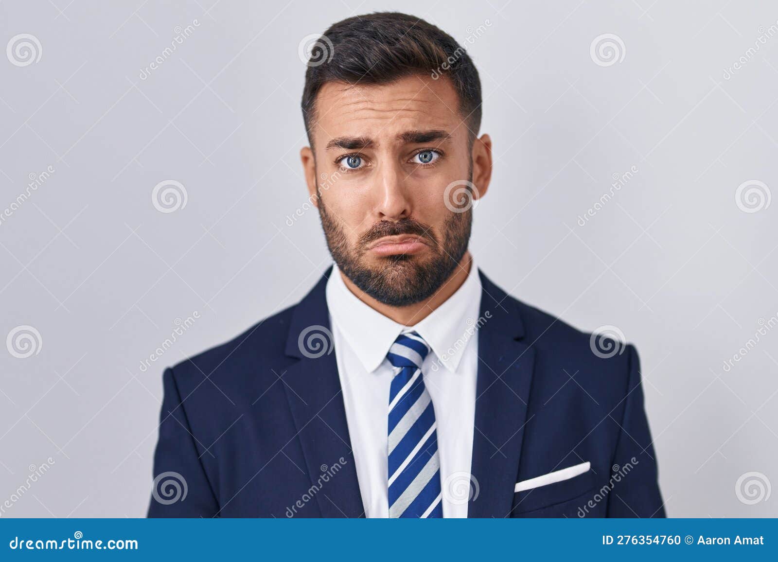 Handsome Hispanic Man Wearing Suit And Tie Depressed And Worry For