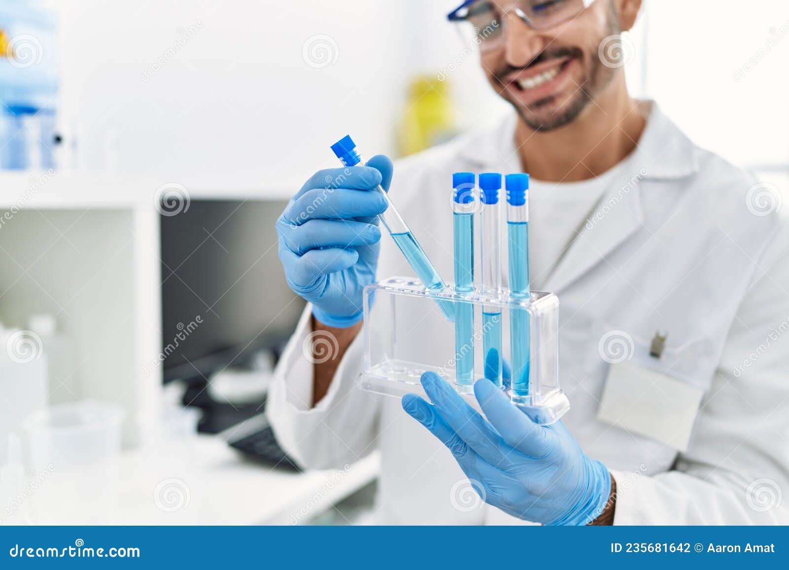 Handsome Hispanic Man Working As Scientific Holding Test Tubes at ...