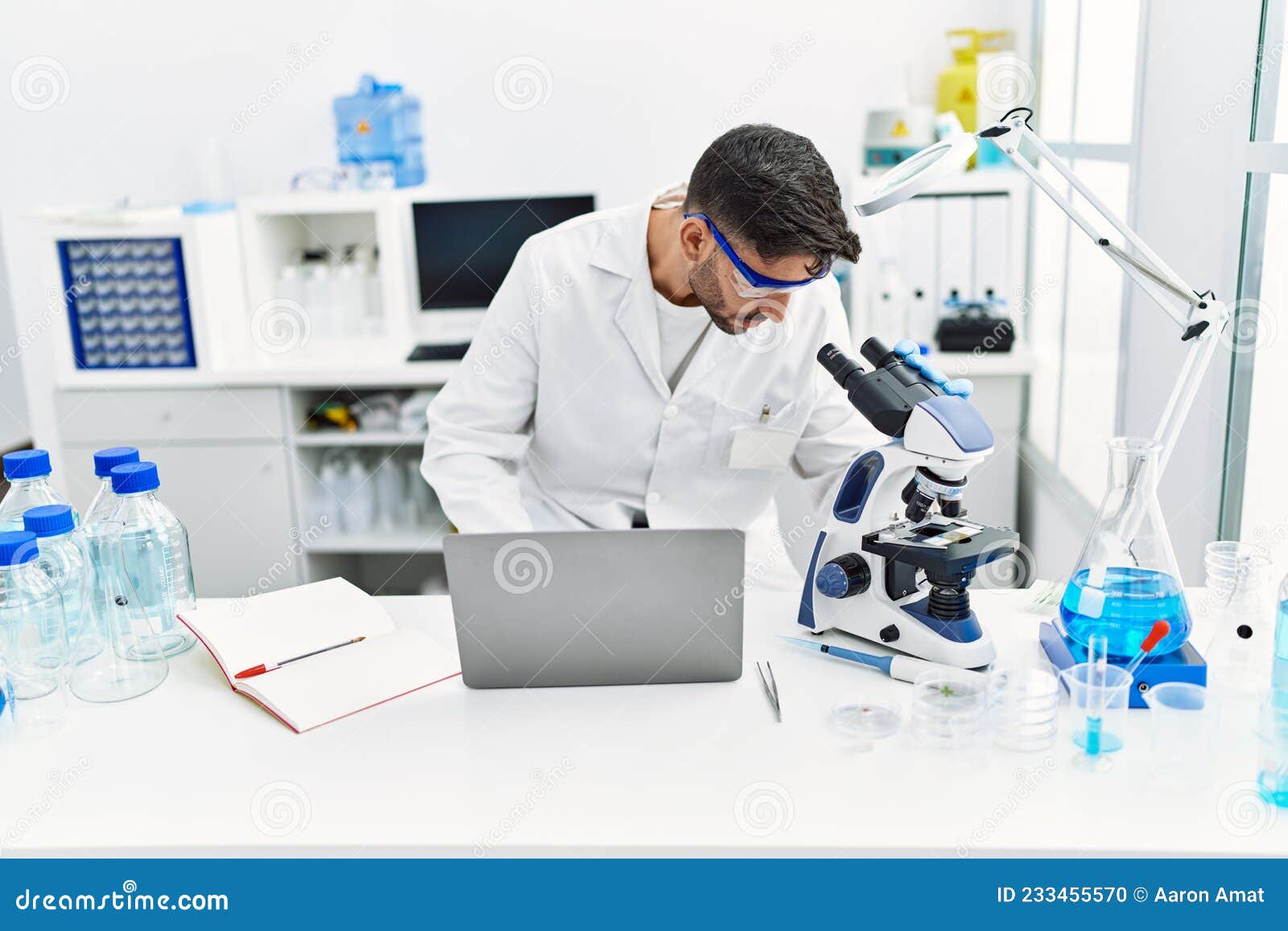Handsome Hispanic Man Working As Scientific with Microscope and Laptop ...