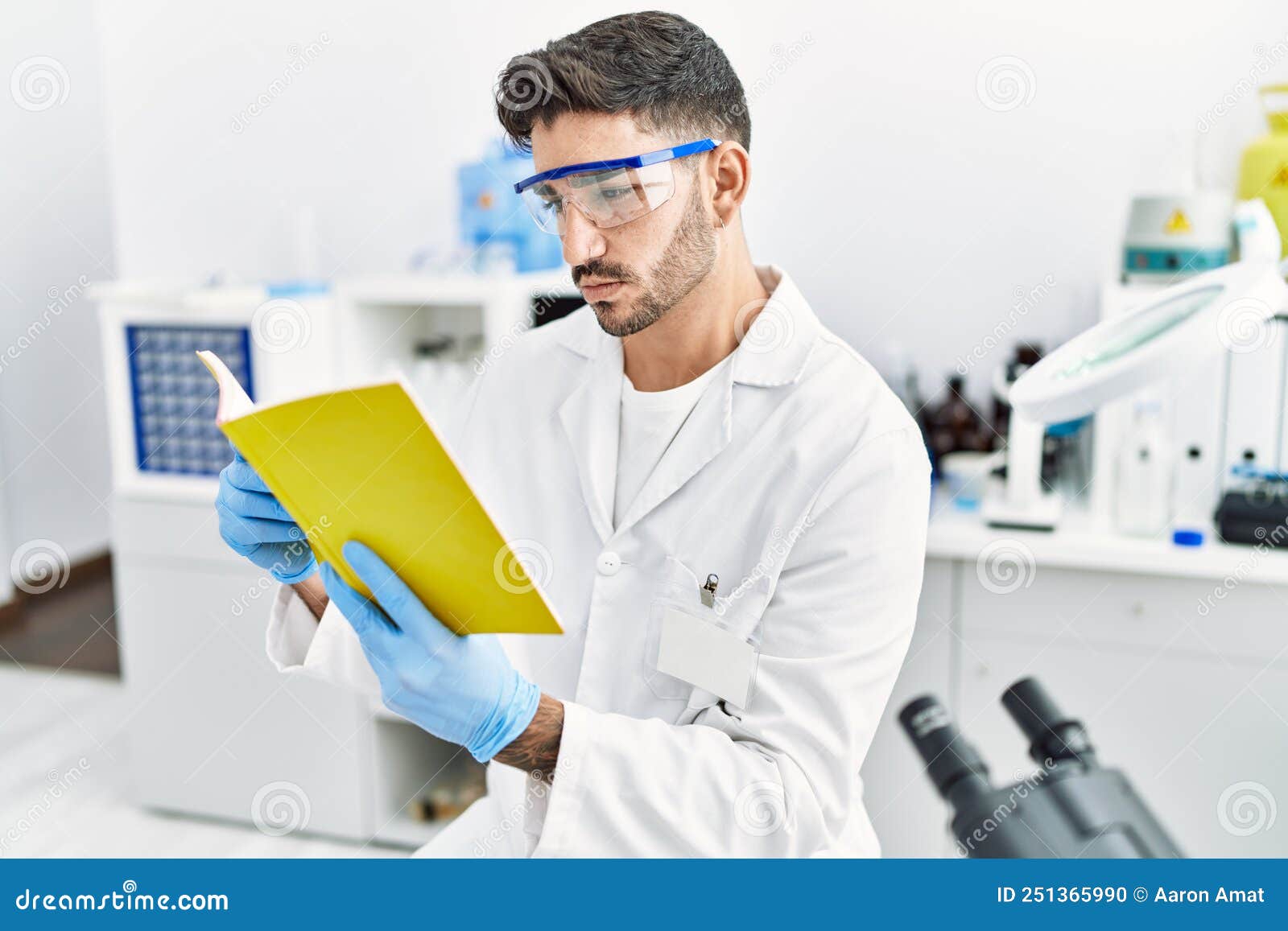 Handsome Hispanic Man Working As Scientific Reading a Book at ...