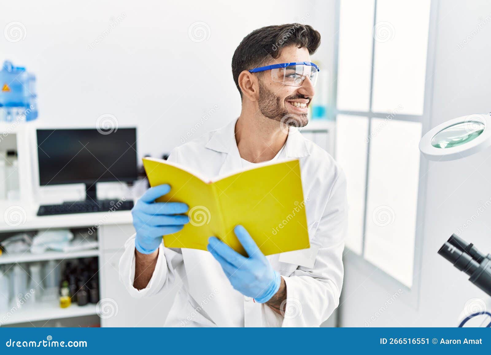 Handsome Hispanic Man Working As Scientific Reading a Book at ...