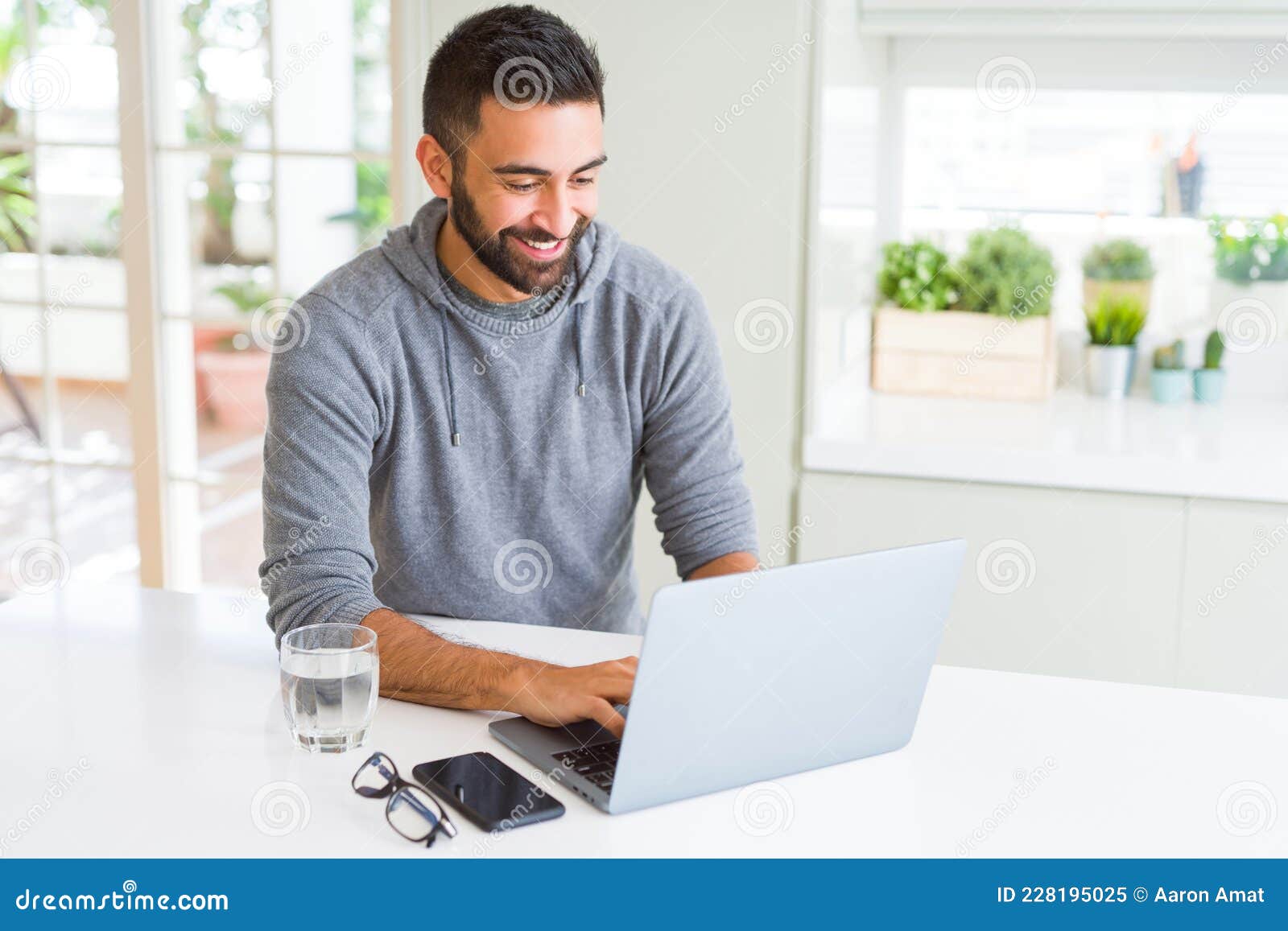 Handsome Hispanic Man Working Using Computer Laptop with a Happy Face ...