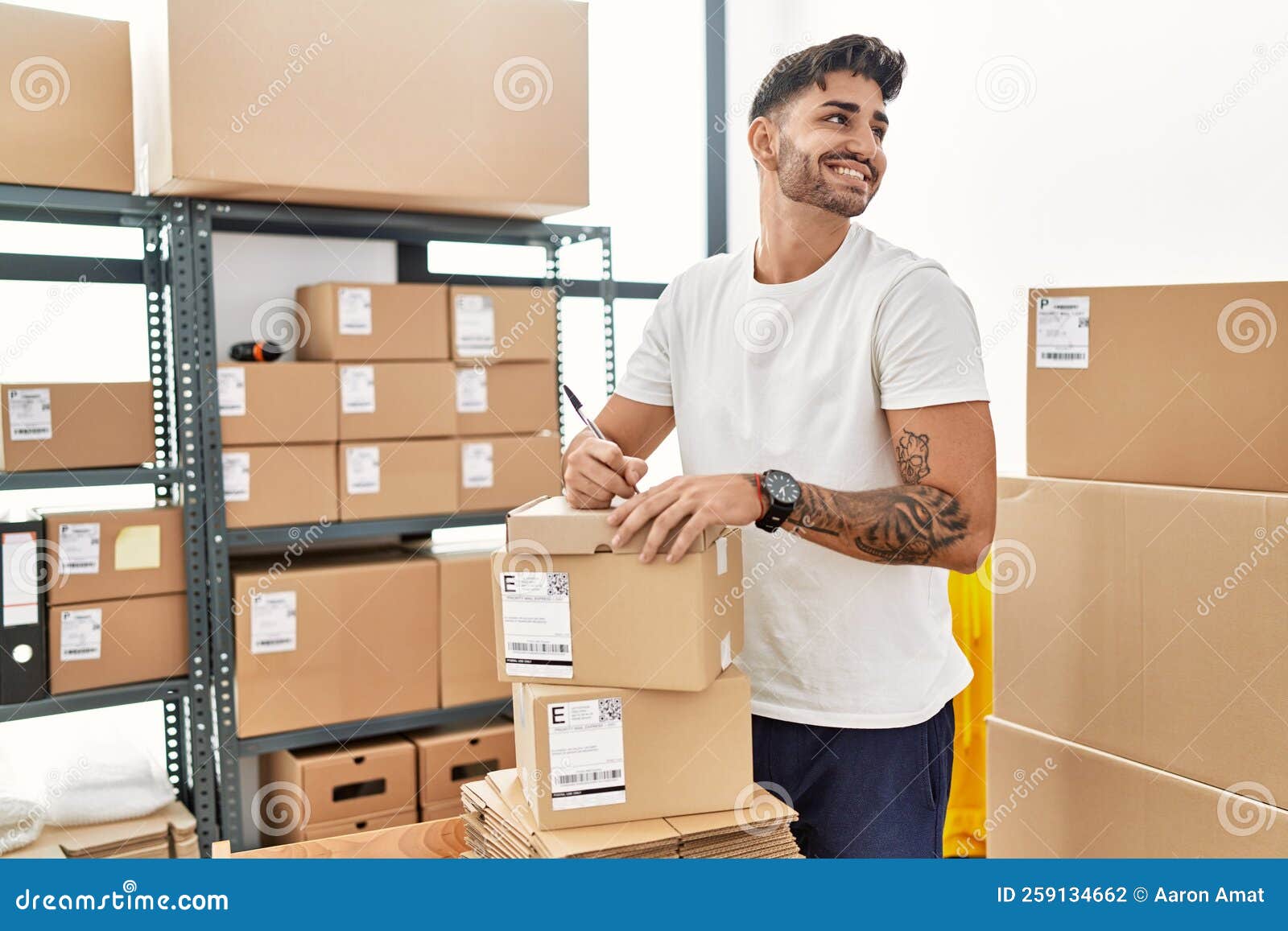 Handsome Hispanic Man Writing Address on Cardboard Boxes at E-commerce ...