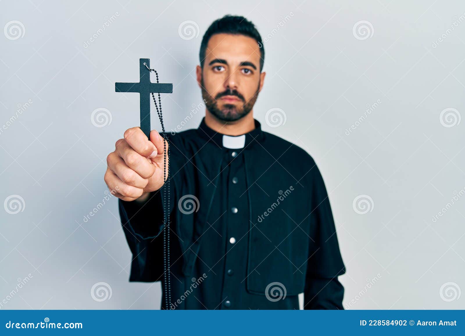 Handsome Hispanic Priest Man with Beard Holding Catholic Cross Thinking ...
