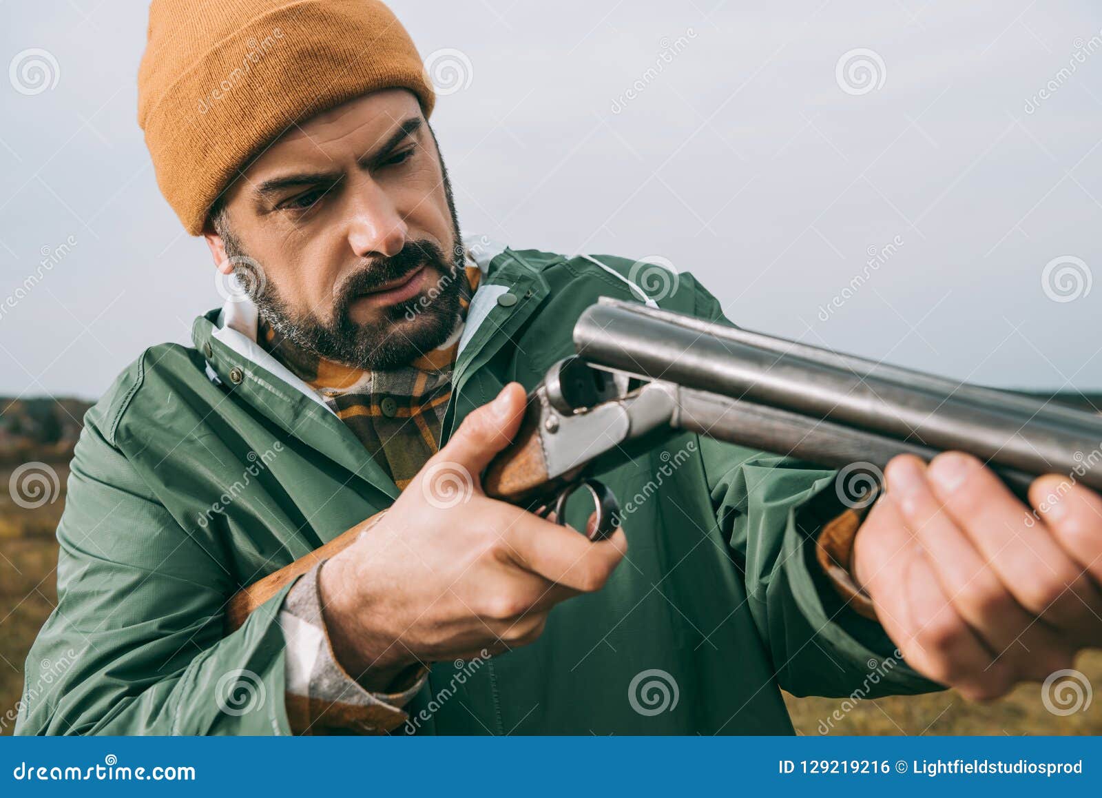 Handsome Hunter in Hat Loading Stock Photo - Image of youngadult ...