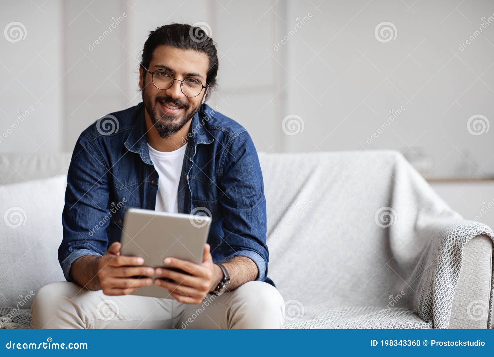 Handsome Indian Guy with Digital Tablet Computer Sitting on Couch at ...