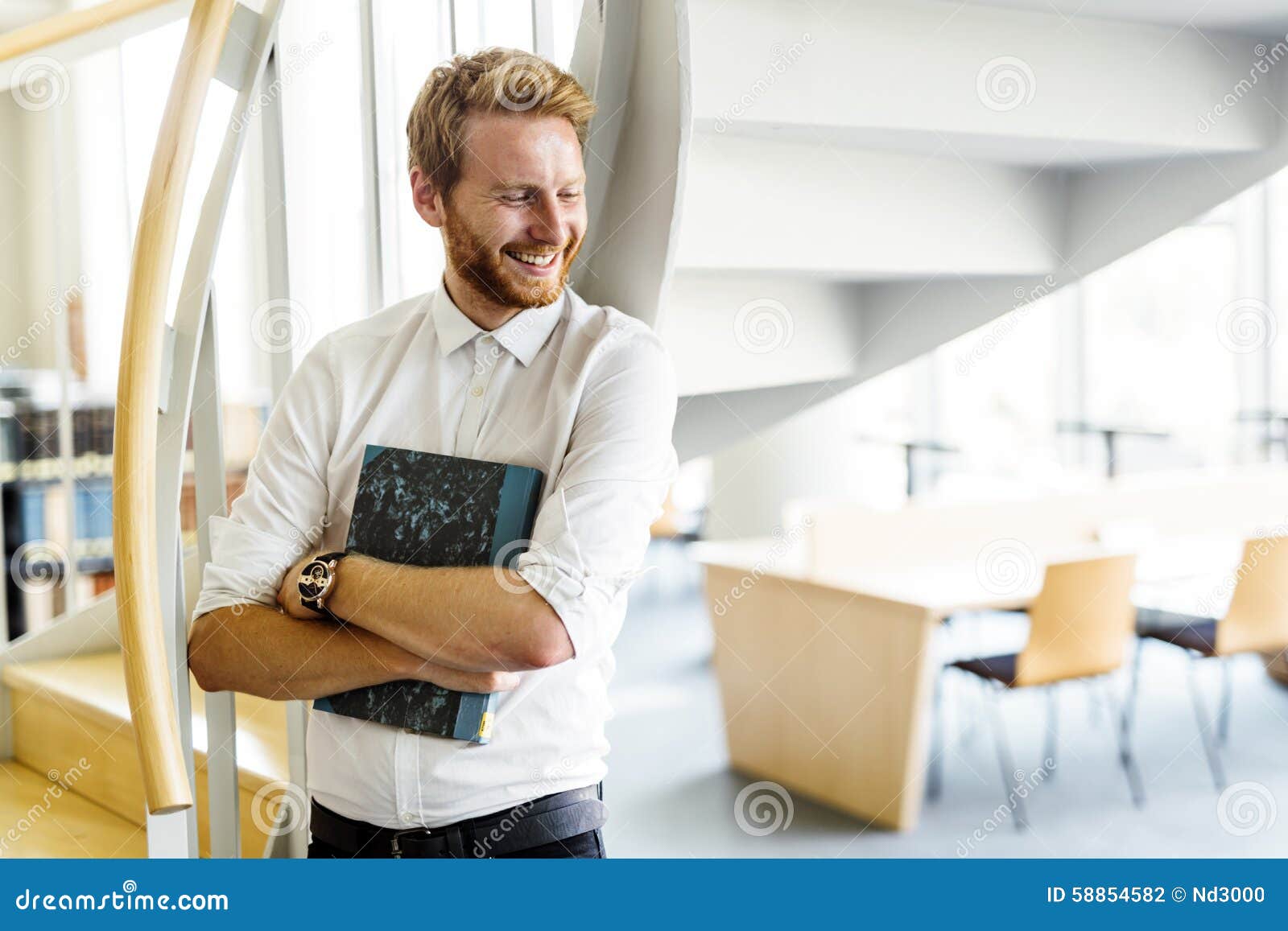 Handsome Intelligent Guy Reading a Book in a Library Stock Photo ...