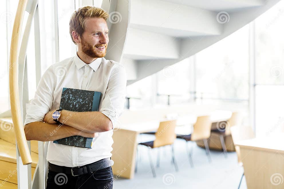 Handsome Intelligent Guy Reading a Book in a Library Stock Photo ...