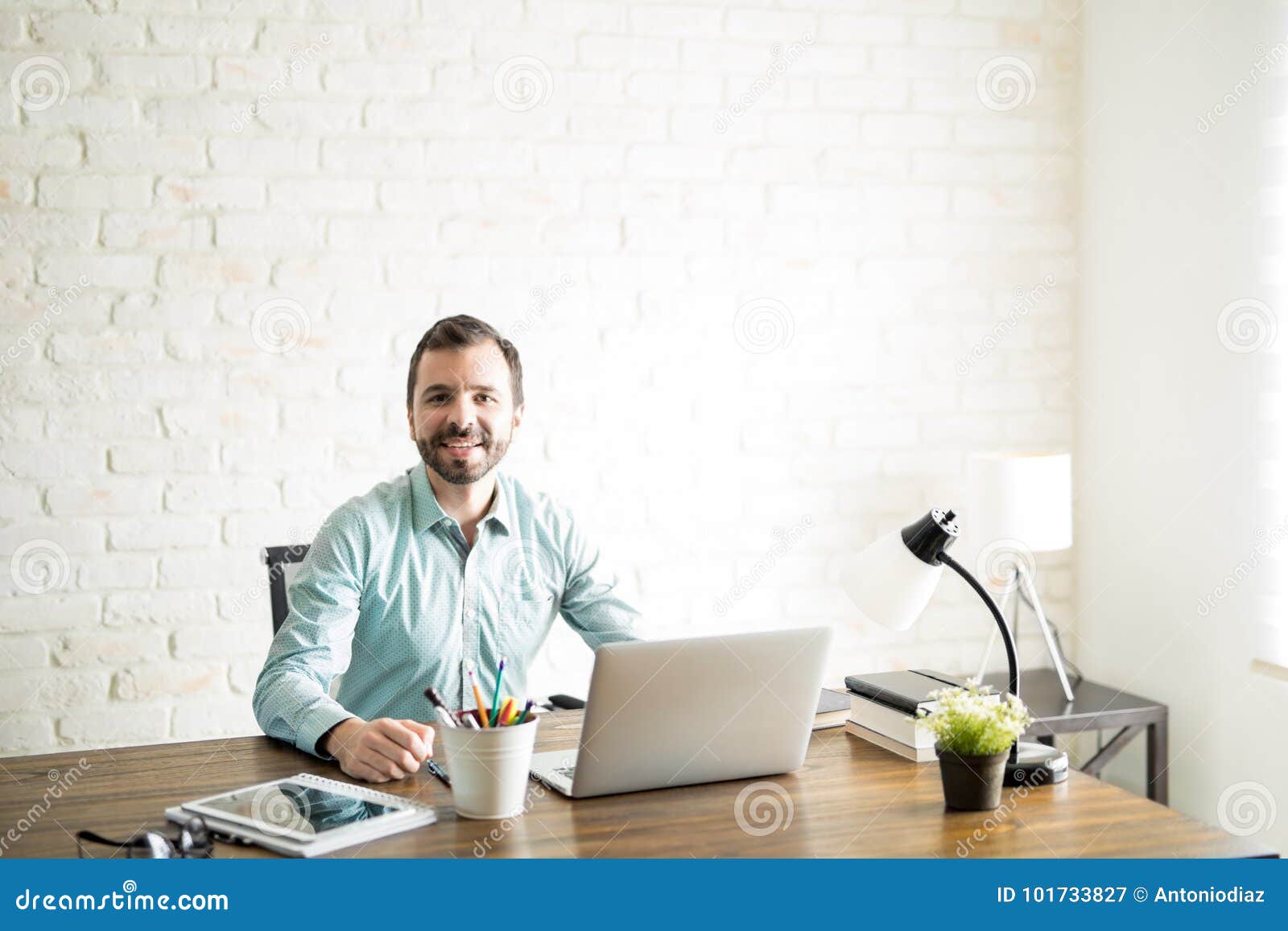 Handsome Latin man at work stock image. Image of trendy - 101733827