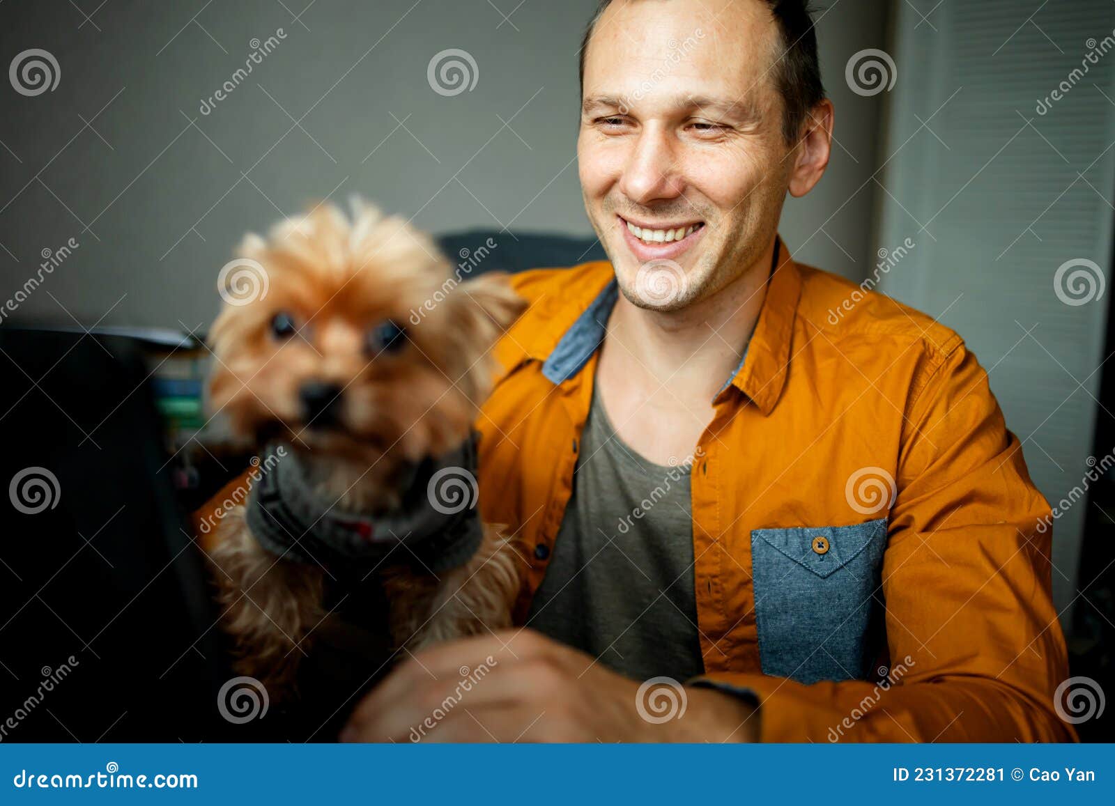 Handsome Laughing Man Using Laptop with Dog at Home. Stock Image ...