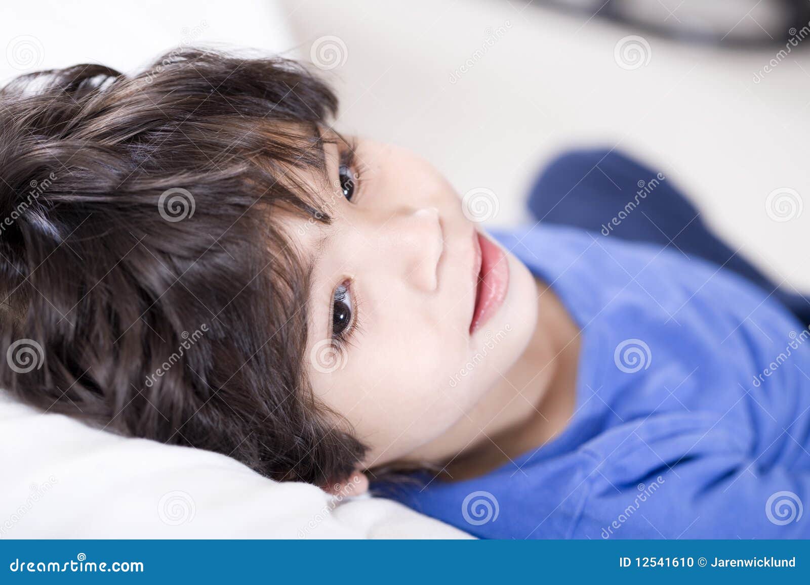 Handsome Little Boy Resting Quietly Stock Photo - Image of blue, lying ...