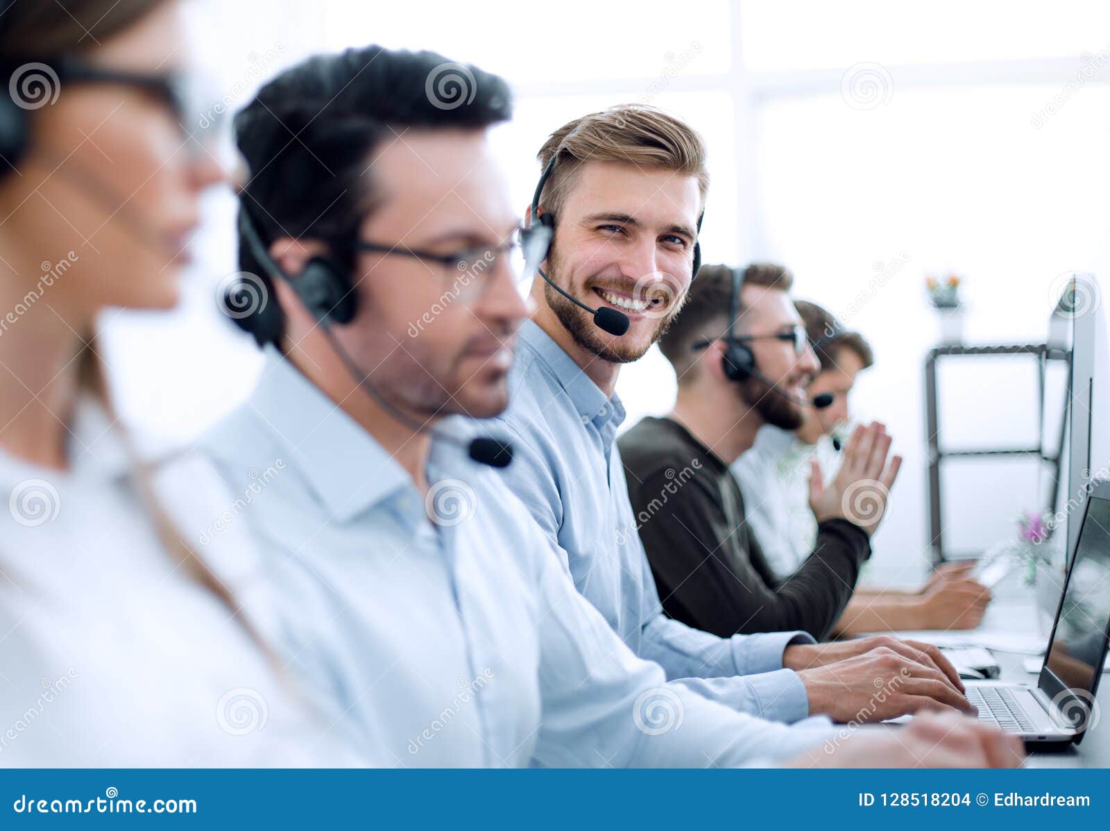 Handsome Male Customer Support Phone Operator with Headset Working in ...