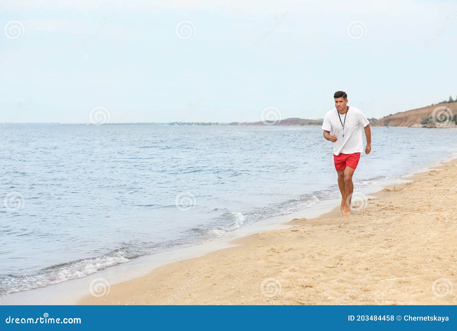 Handsome Male Lifeguard Running on Sandy Beach Stock Photo - Image of ...