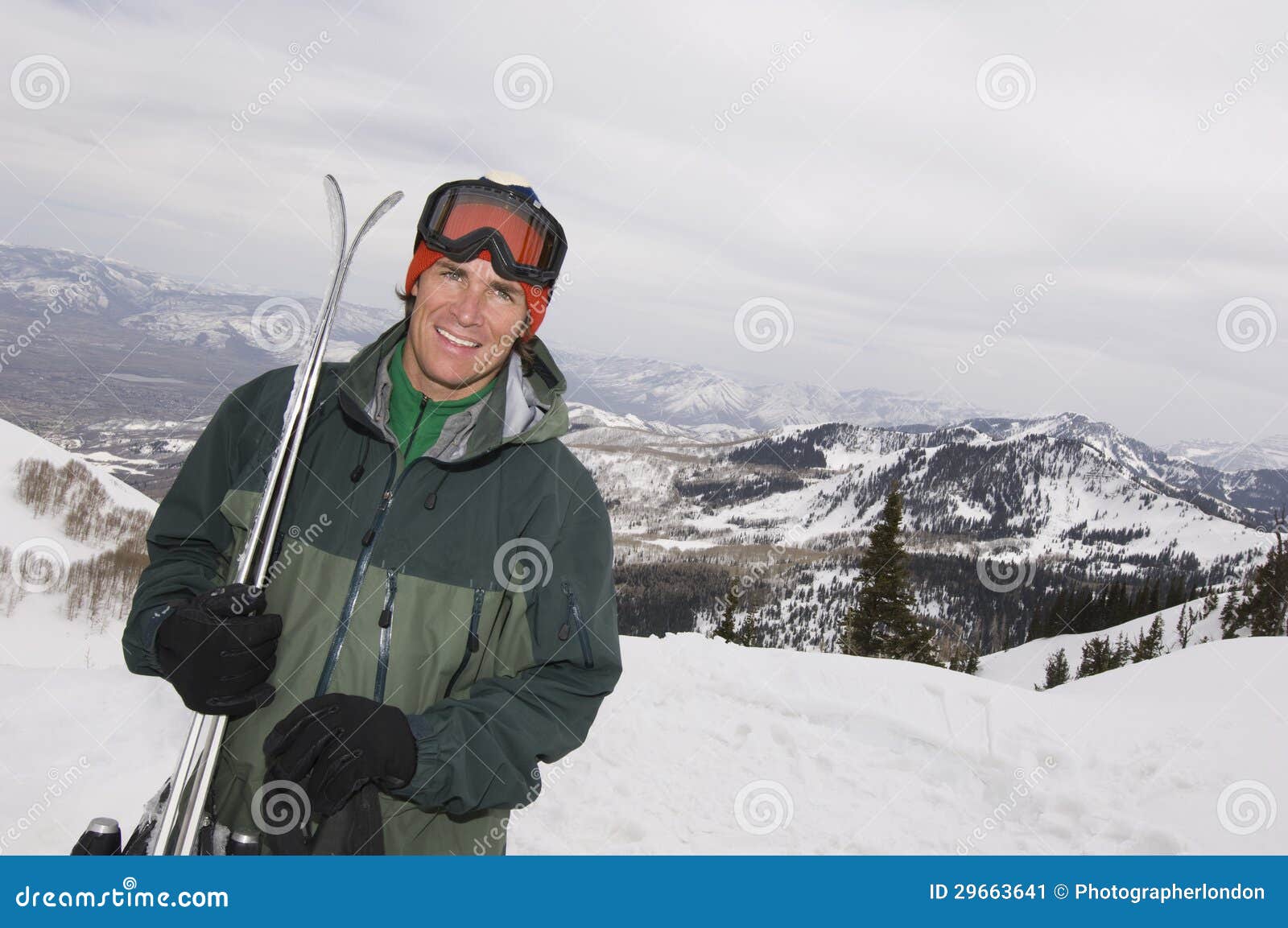 Handsome Male Skier Holding Skis Stock Image - Image of area, looking ...