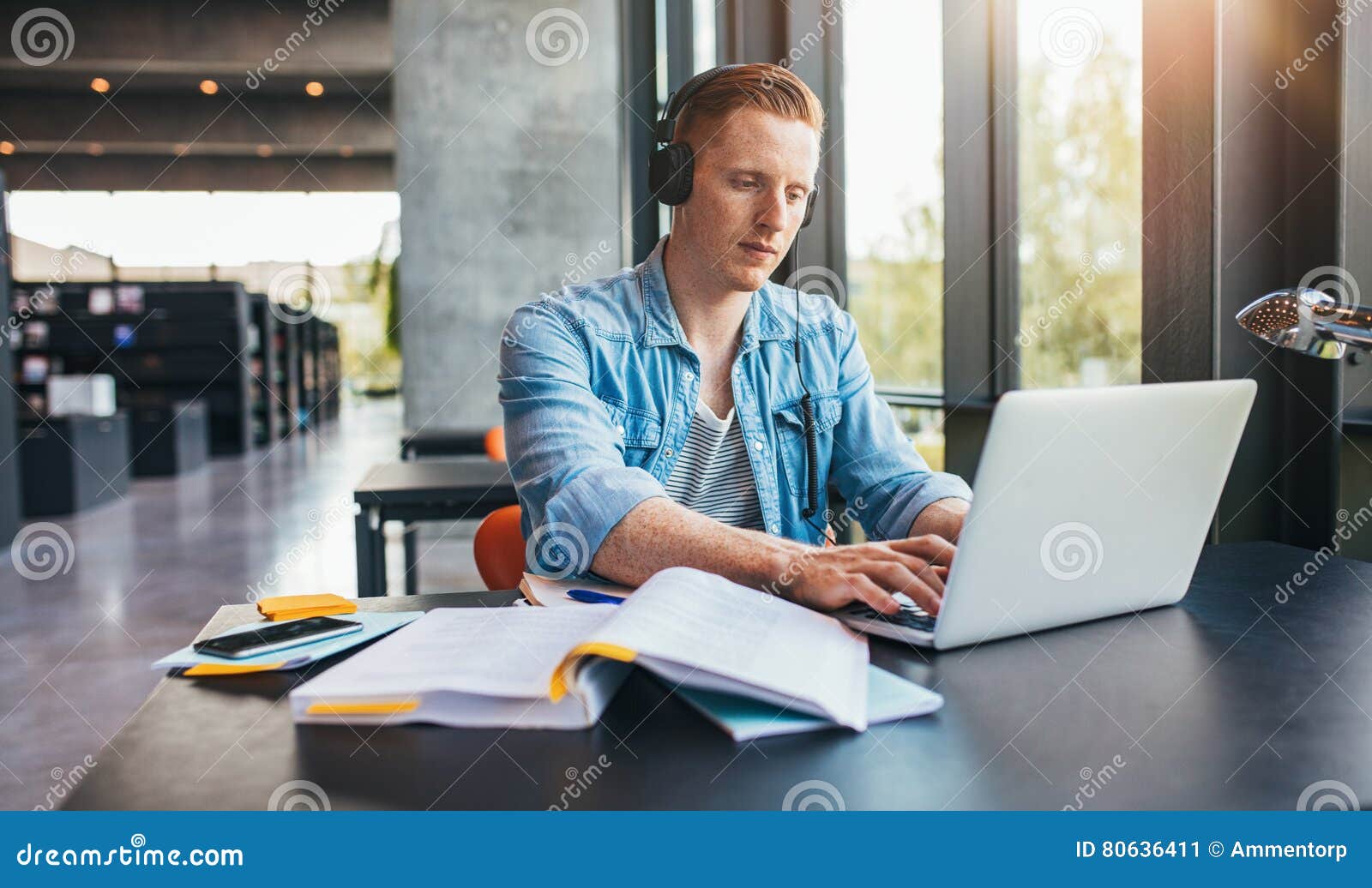 Handsome Male Student in a University Library Stock Image - Image of ...