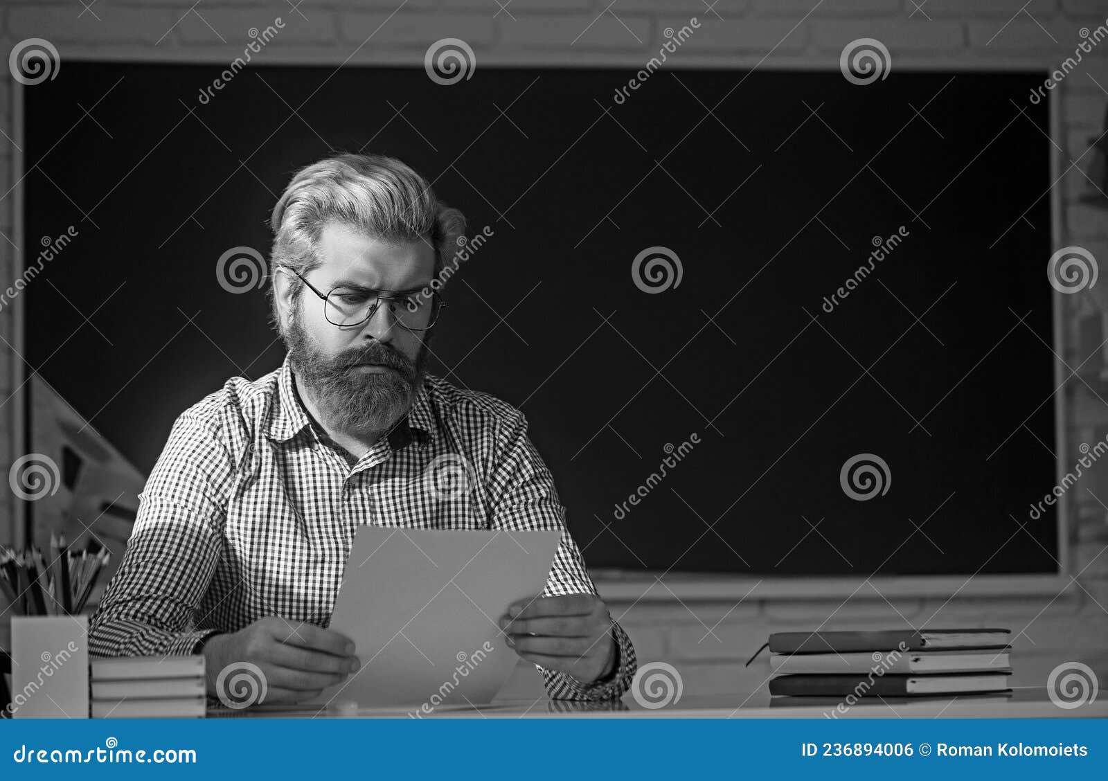 Handsome Male Teacher Checking Homework in Classroom. Stock Photo ...