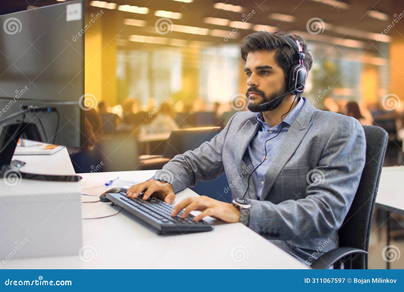 Handsome Male Technical Support Operator Working at His Workplace in ...